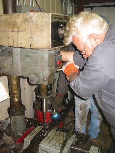 Al drilling holes in frame brace